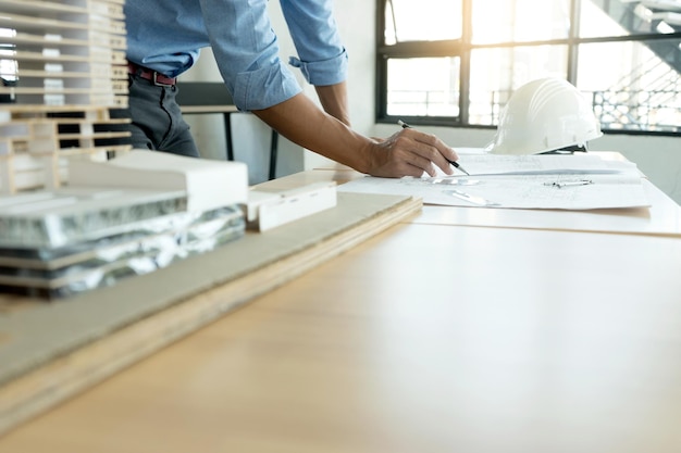 Premium Photo | Midsection of architect drawing blueprint in office Premium Photo | Midsection of architect drawing blueprint in office