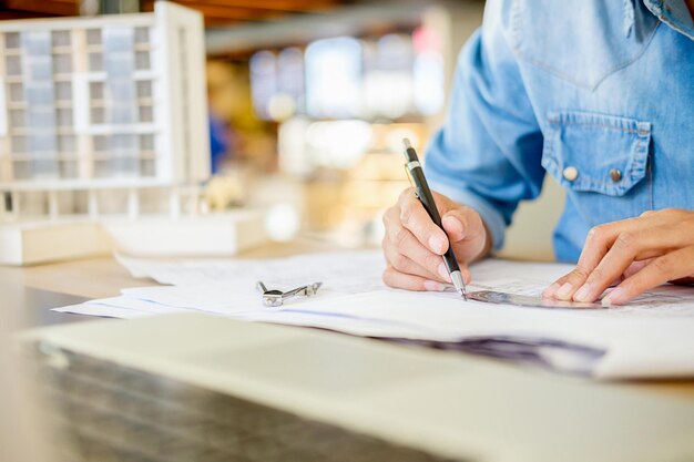 Premium Photo | Midsection of female architect working at desk Premium Photo | Midsection of female architect working at desk