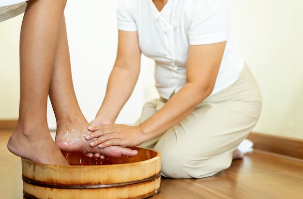 Premium Photo Midsection Of Woman Giving Foot Massage