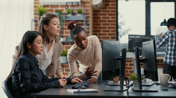 Premium Photo | Mixed team of programmers brainstorming ideas for new code library in front of ...