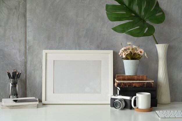 Premium Photo | Mockup blank frame poster on hipster workspace Premium Photo | Mockup blank frame poster on hipster workspace