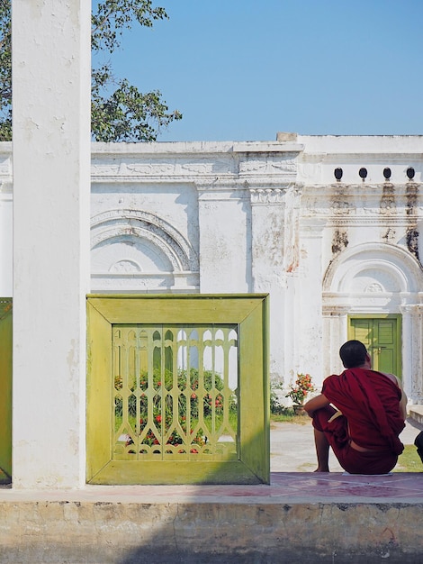 Premium Photo | Monk sitting on doorway of temple Premium Photo | Monk sitting on doorway of temple