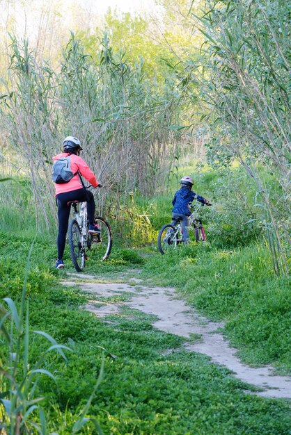 Premium Photo | Mother and daughter cycling in the forest together Premium Photo | Mother and daughter cycling in the forest together
