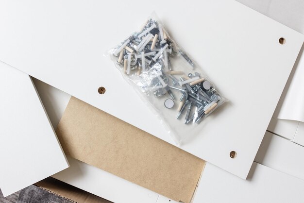 Premium Photo | Opened box with furniture assembly parts and tools on ... Premium Photo | Opened box with furniture assembly parts and tools on ...