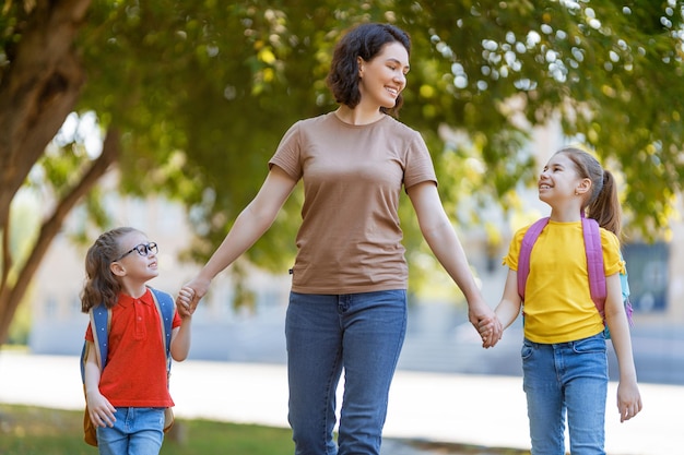 Premium Photo | Parent and pupils go to school Premium Photo | Parent and pupils go to school