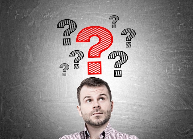 Premium Photo | Pensive bearded man and question marks Premium Photo | Pensive bearded man and question marks