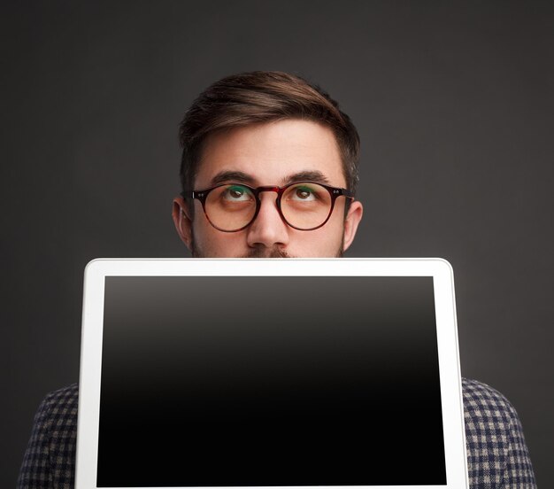 Premium Photo | Pensive man showing laptop Premium Photo | Pensive man showing laptop