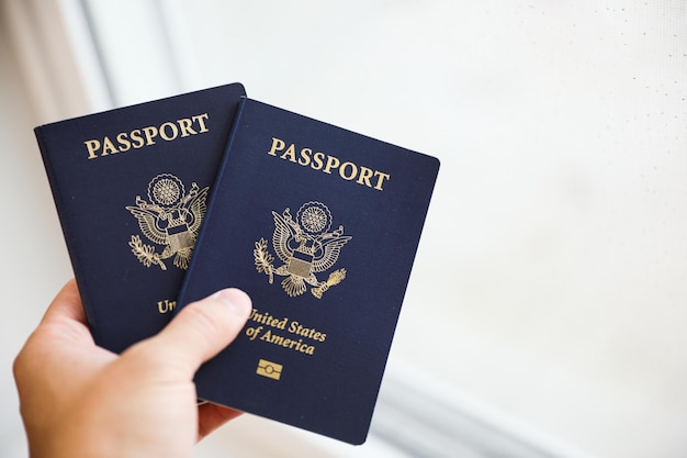 Premium Photo A Person Holding Two Passports With The Word Passport