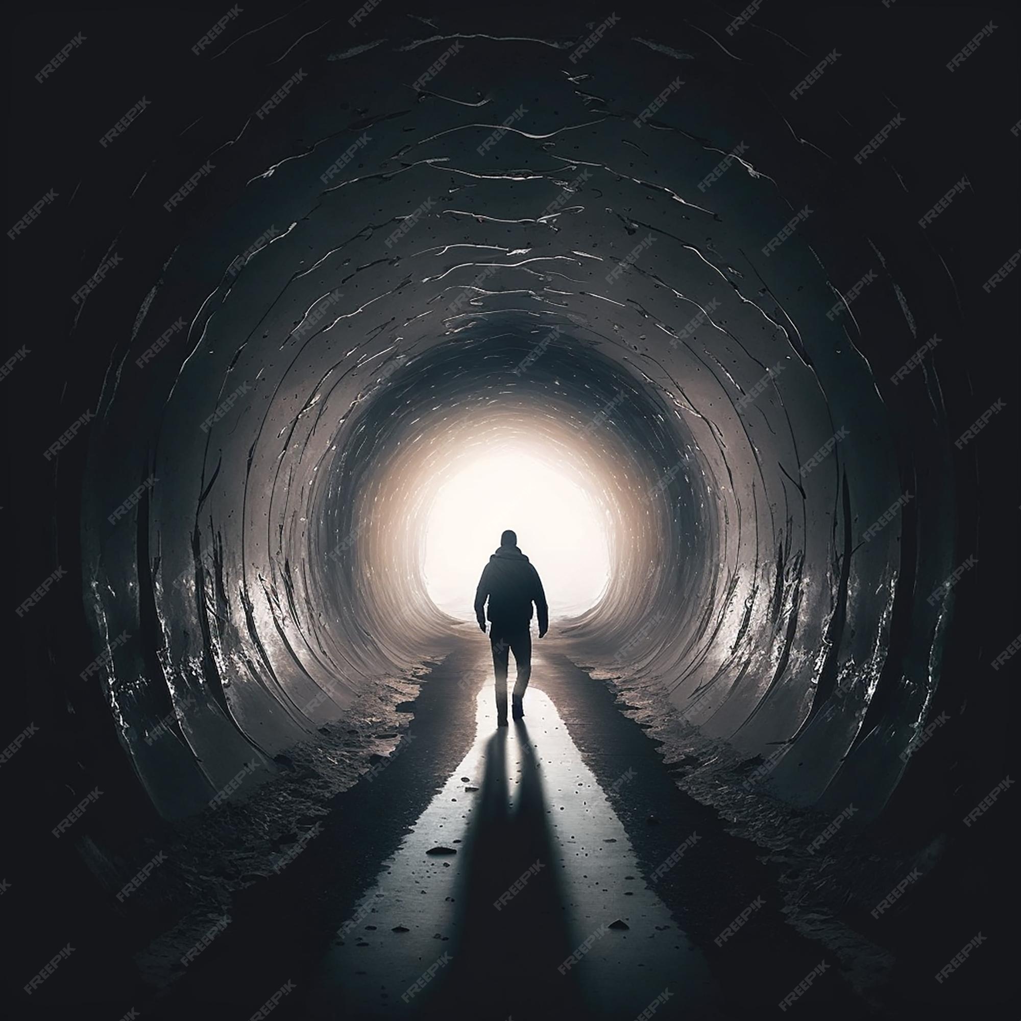Person walks along long dark tunnel towards the light, symbol of hope ... Person walks along long dark tunnel towards the light, symbol of hope ...