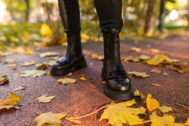 Premium Photo A Person Wearing Black Boots Stands On A Wet Ground