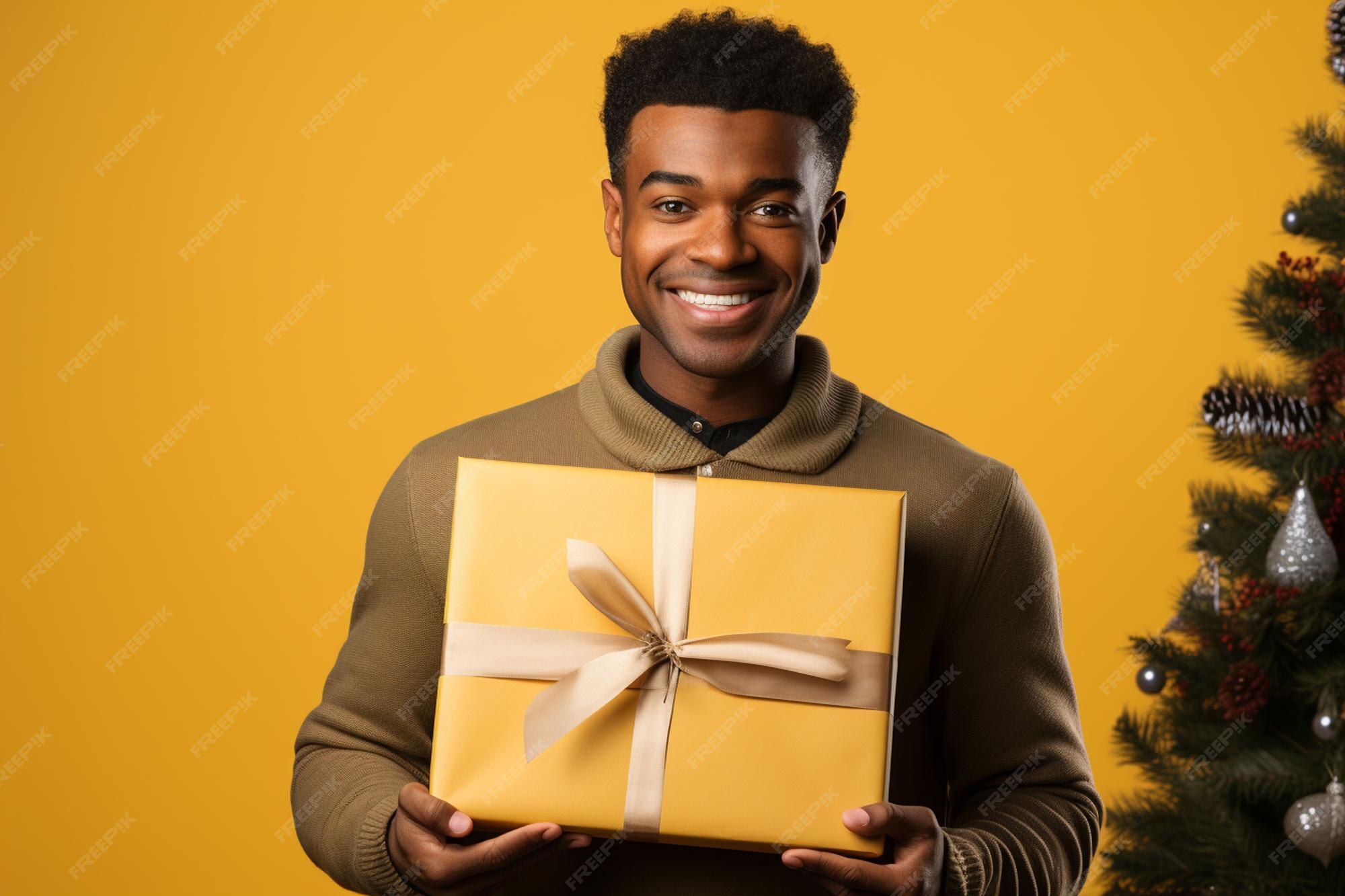 Premium AI Image | photo front view young man with santa hat holding ... Premium AI Image | photo front view young man with santa hat holding ...