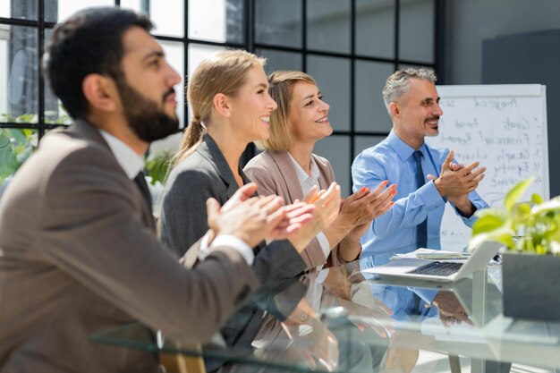 Premium Photo | Photo of happy business people applauding at conference Premium Photo | Photo of happy business people applauding at conference
