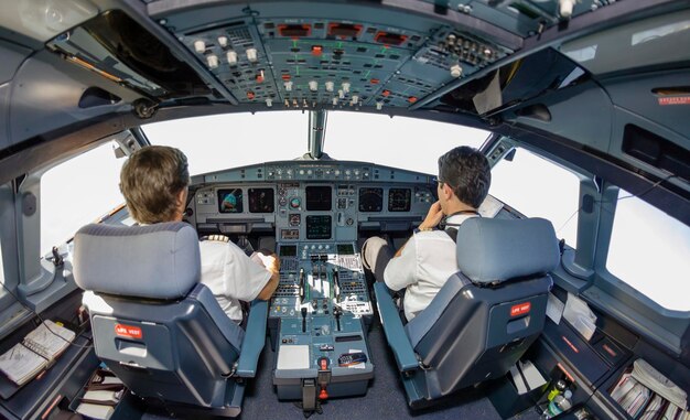 Premium Photo | Pilots in an airplane cockpit Premium Photo | Pilots in an airplane cockpit