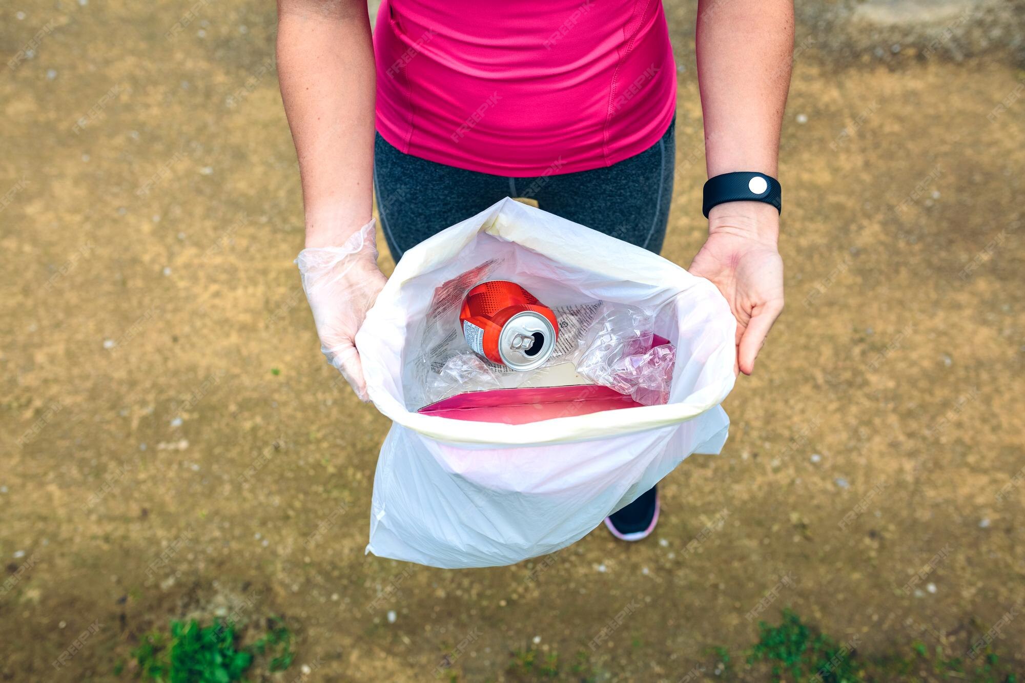 Premium Photo | Plogging girl showing garbage Premium Photo | Plogging girl showing garbage