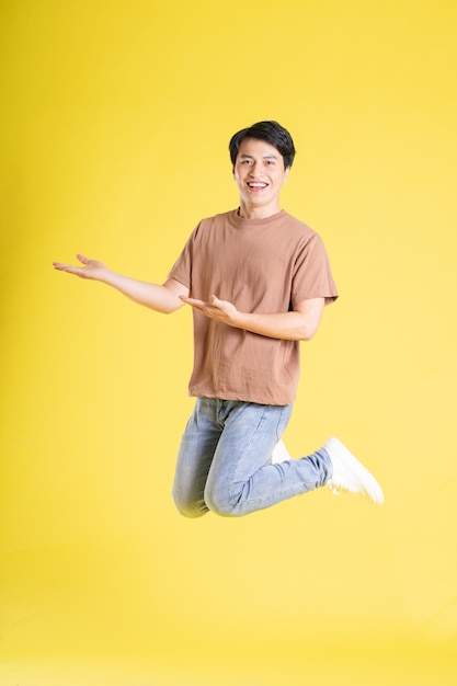 Premium Photo Portrait Of Asian Man Posing On Yellow Background