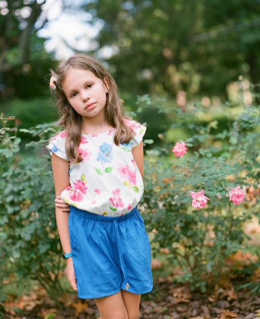 Premium Photo Portrait Of Cute Girl Standing Against Plants