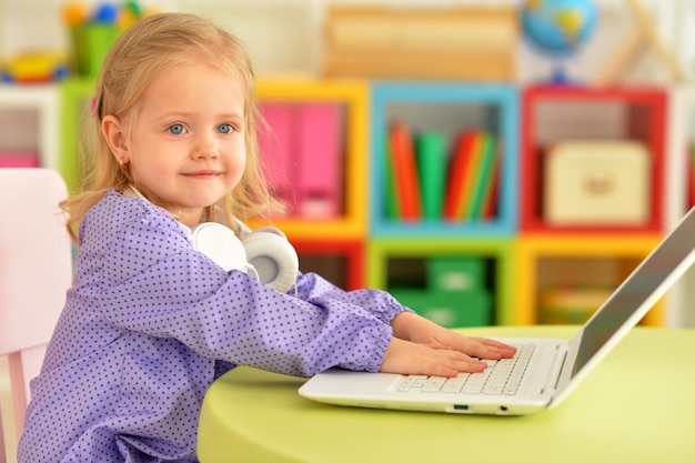 Premium Photo Portrait Of Cute Girl Using Laptop At Home