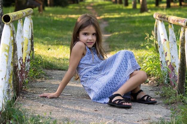 Premium Photo | Portrait of girl sitting at park outdoors Premium Photo | Portrait of girl sitting at park outdoors
