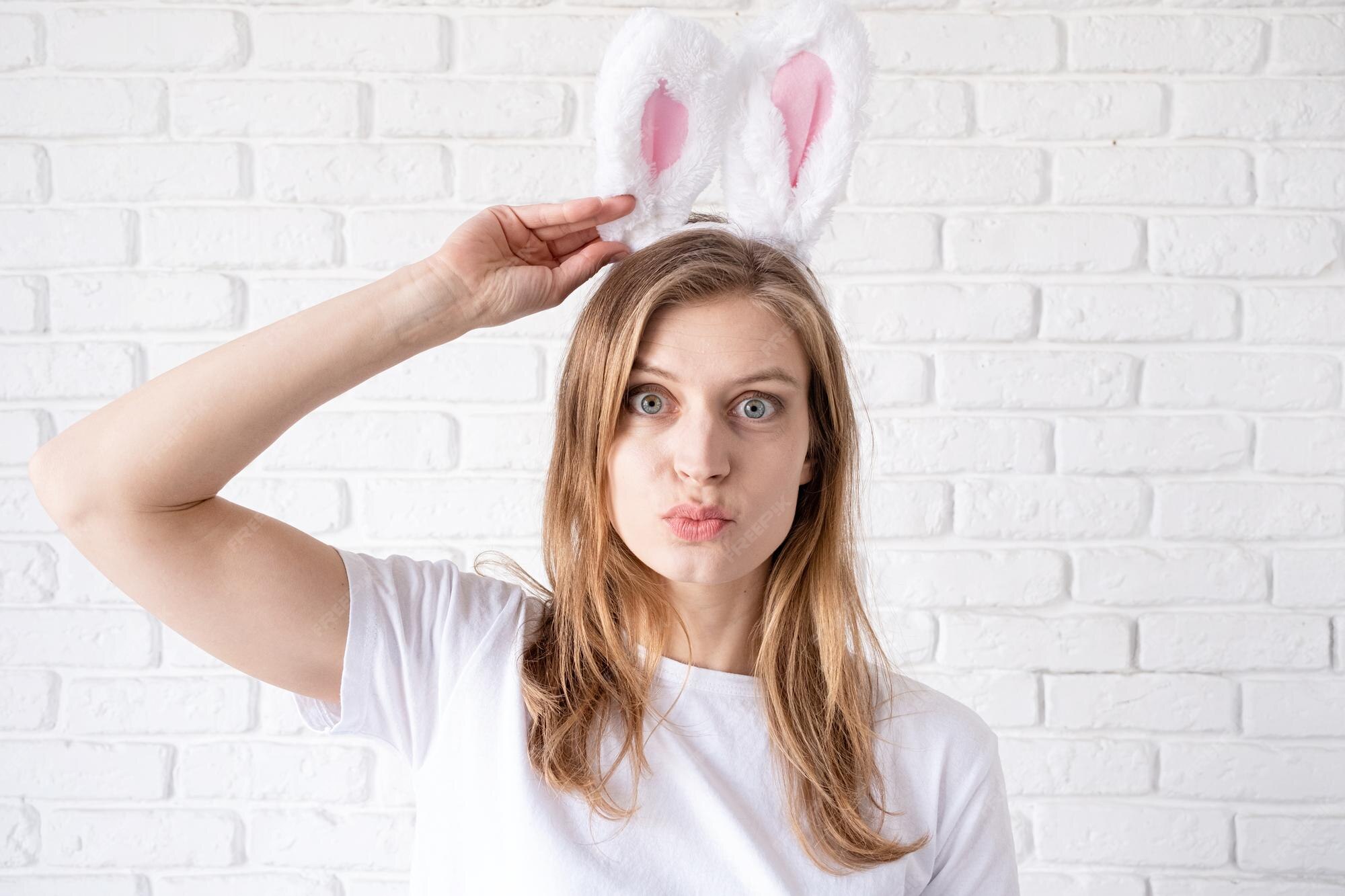 Premium Photo Portrait Of A Happy Woman In Bunny Ears On White Brick