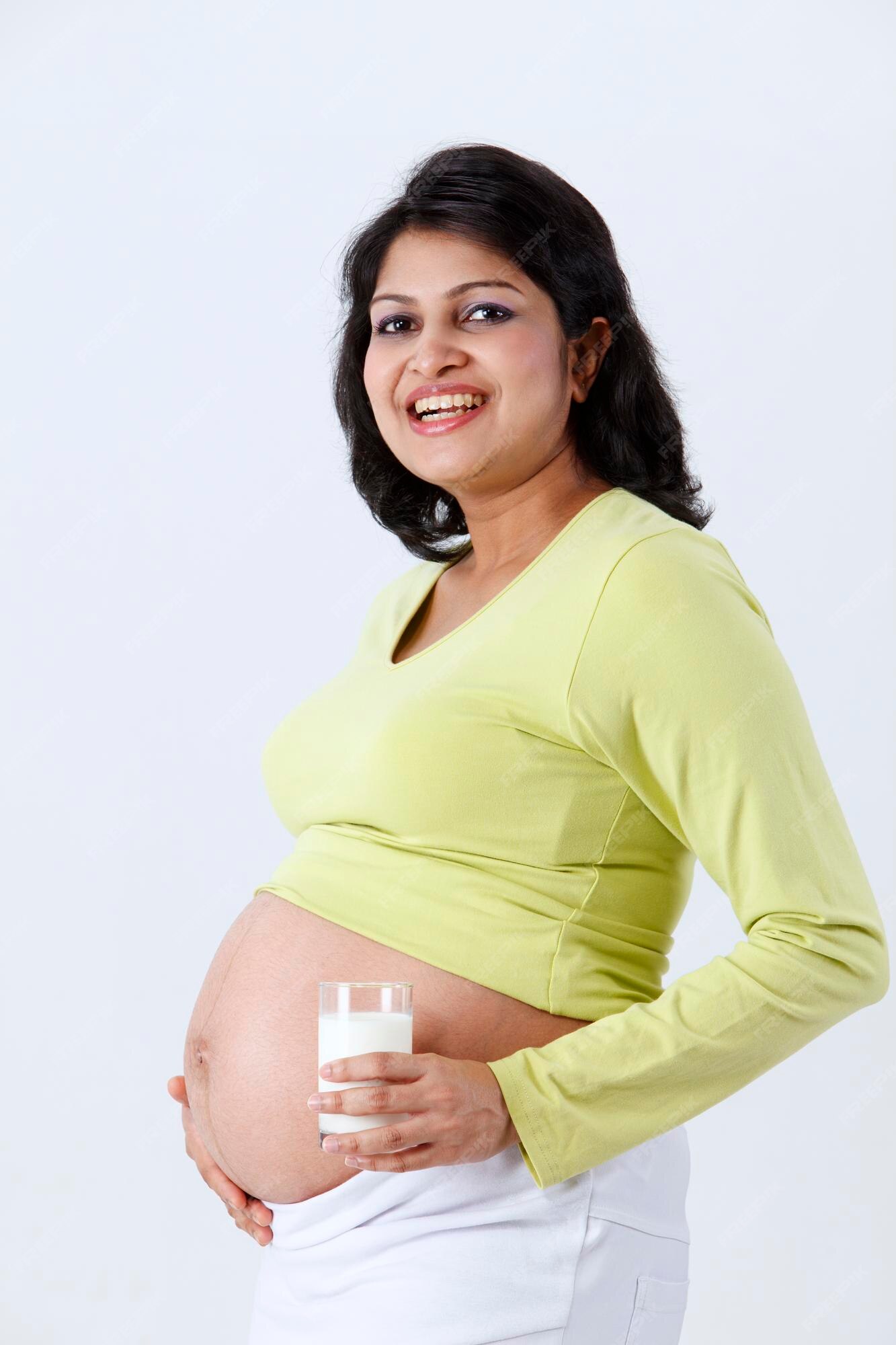 Premium Photo Portrait Of Pregnant Woman Holding Milk In Glass While