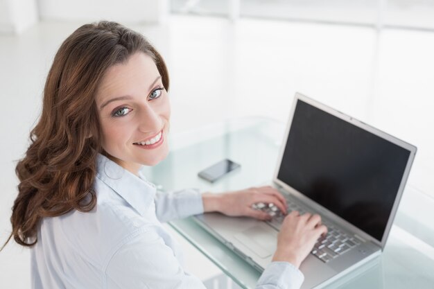Premium Photo | Portrait of smiling brown haired businesswoman using laptop Premium Photo | Portrait of smiling brown haired businesswoman using laptop