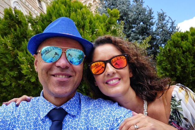 Premium Photo Portrait Of Smiling Couple Wearing Sunglasses