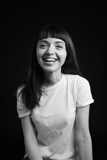 Premium Photo Portrait Of Smiling Girl Against Black Background