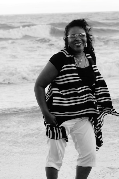 Premium Photo Portrait Of Smiling Mature Woman Standing Against Sea