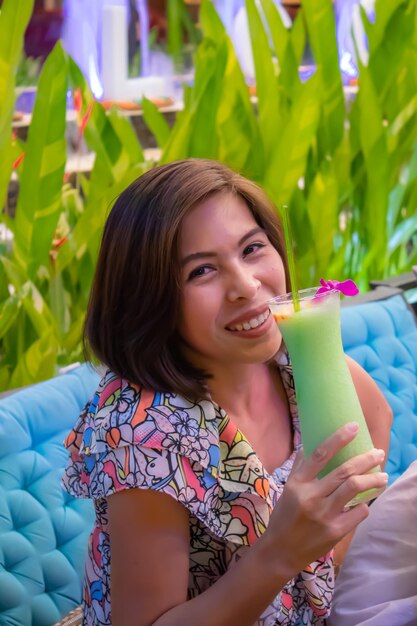 Premium Photo Portrait Of A Smiling Young Woman Drinking Glass