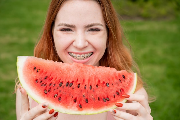 Premium Photo | Portrait of a smiling young woman holding fruit Premium Photo | Portrait of a smiling young woman holding fruit
