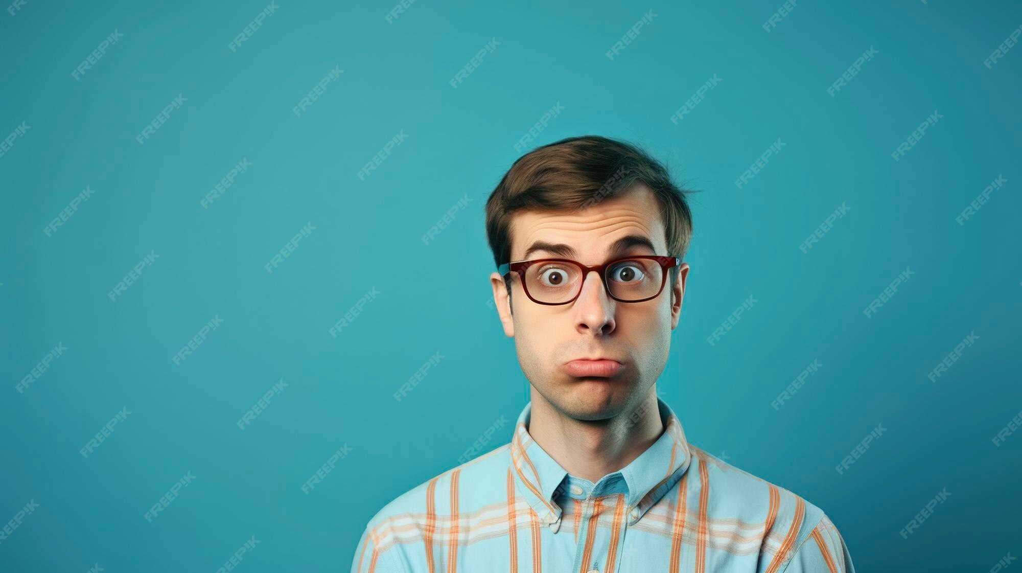 Premium Photo Portrait Of A Young Man In Glasses Nerd With A Funny Face Expression On Blue