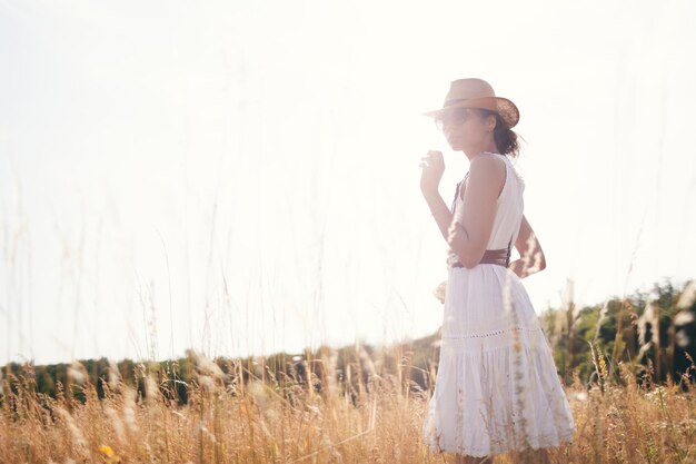 Premium Photo Portrait Of Young Woman Walking Among High Grasses In