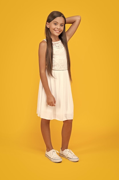 Premium Photo Positive Teen Girl In White Dress Standing On Yellow