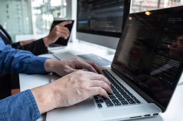 Premium Photo | Professional team of programmer working on project in ...