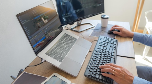 Premium Photo | Programmer drinking coffee while using laptop on table Premium Photo | Programmer drinking coffee while using laptop on table