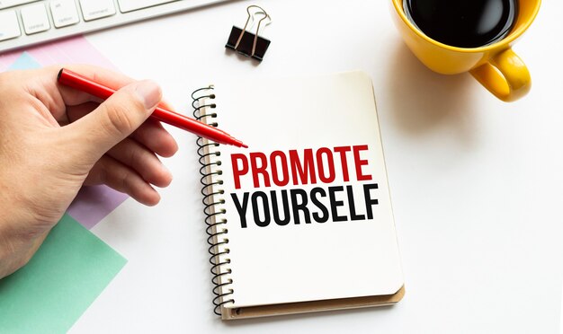 Premium Photo | Promote yourself sign in the notepad Premium Photo | Promote yourself sign in the notepad