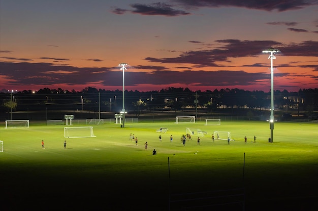Premium Photo Public Sports Stadium With Young People Playing Football Game At Sunset Active