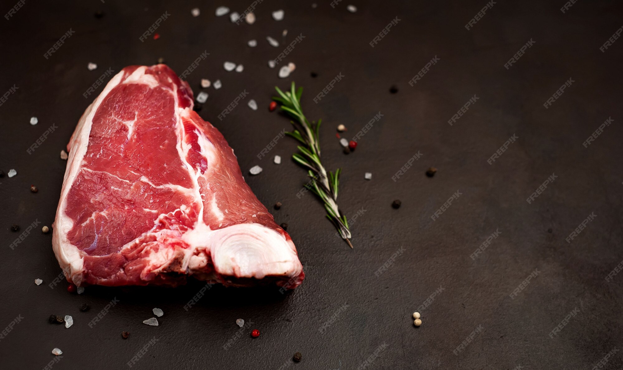 Premium Photo Raw Beef T Bone Steak With Spices On The Background Stone With Copy Space For