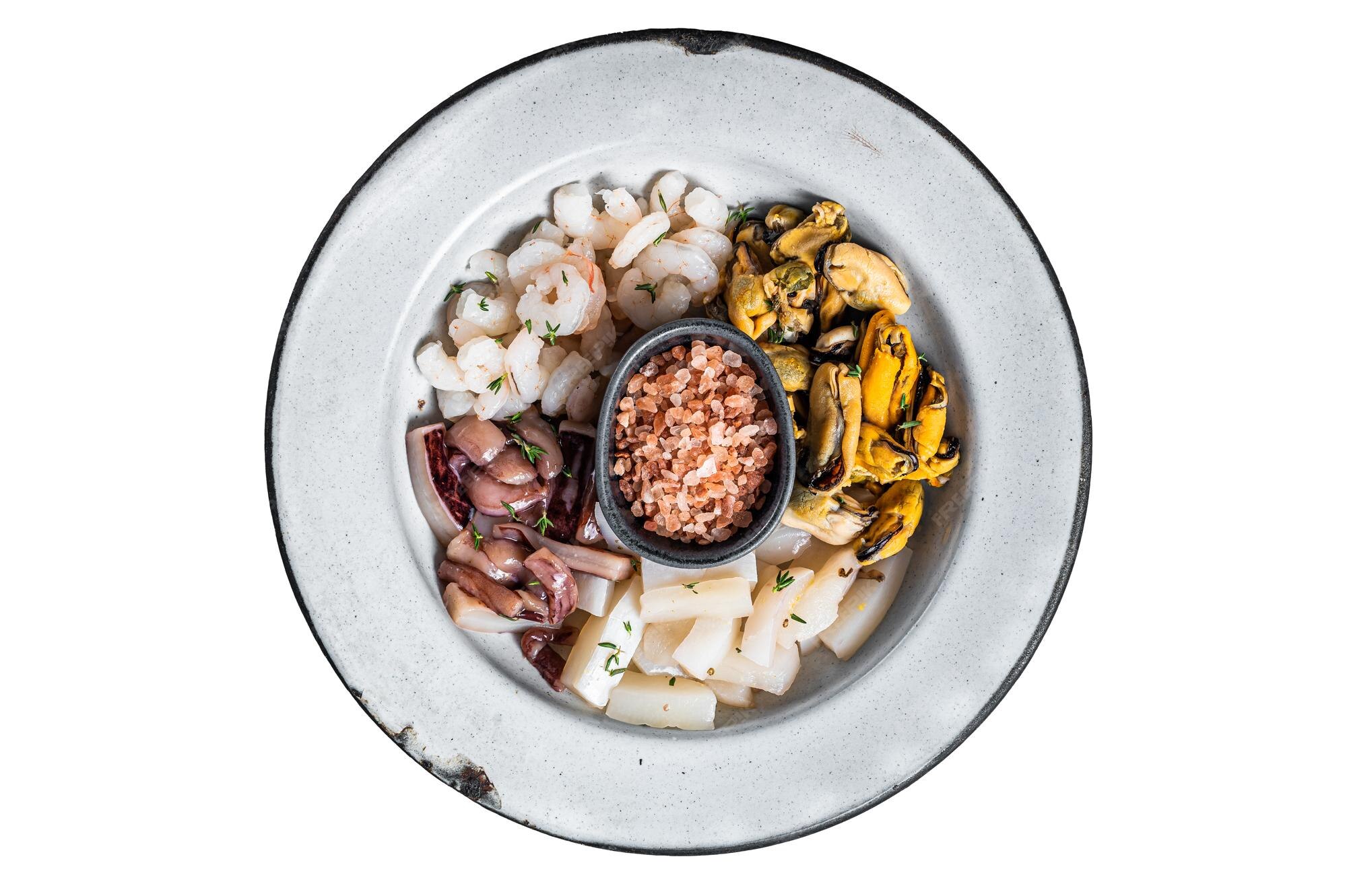 Premium Photo | Raw seafood mix in a rustic plate Isolated white background Premium Photo | Raw seafood mix in a rustic plate Isolated white background