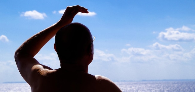Premium Photo | Rear view of bald man against sky at beach Premium Photo | Rear view of bald man against sky at beach