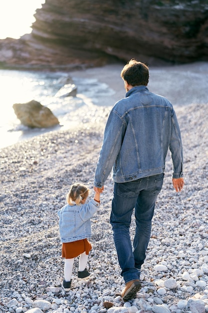 Premium Photo Rear View Of Father And Son On Land