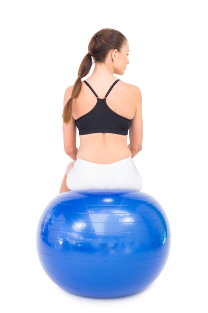 Premium Photo | Rear view of fit woman sitting on exercise ball Premium Photo | Rear view of fit woman sitting on exercise ball