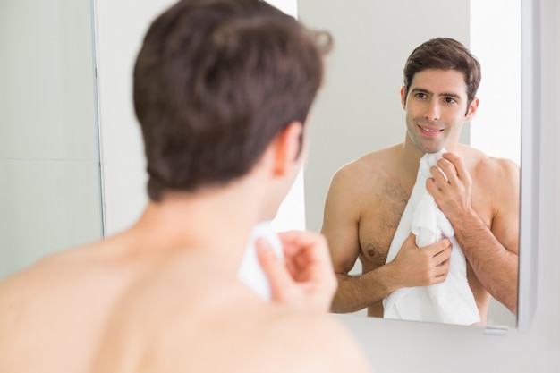 Premium Photo | Rear view of man looking at self in bathroom mirror Premium Photo | Rear view of man looking at self in bathroom mirror