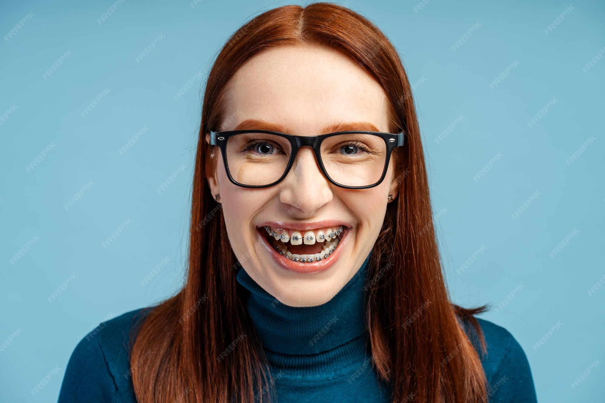 Premium Photo Redhead Woman With Braces Donning Glasses Laughing While Looking At The Camera