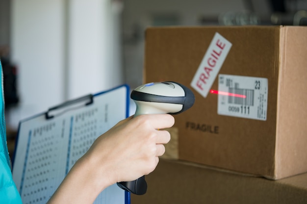 Premium Photo | Scanning boxes with barcode scanner Premium Photo | Scanning boxes with barcode scanner