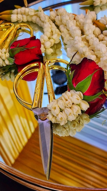 Premium Photo Scissors Decorated With Jasmine Flowers That Will Be Used For The Inauguration