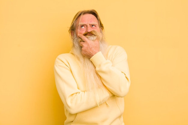 Premium Photo Senior Cool Bearded Man Thinking Feeling Doubtful And