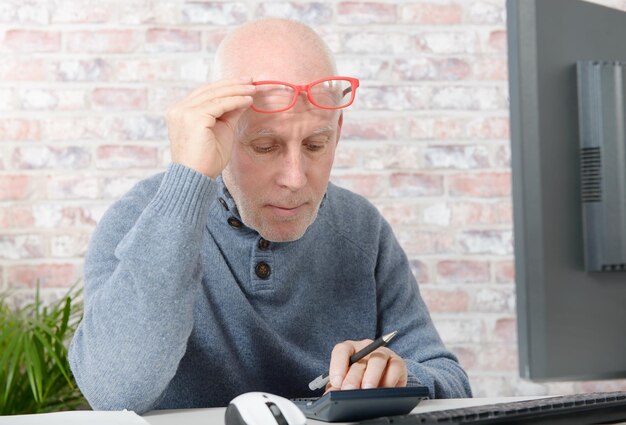 Premium Photo | Senior man using calculator on table Premium Photo | Senior man using calculator on table