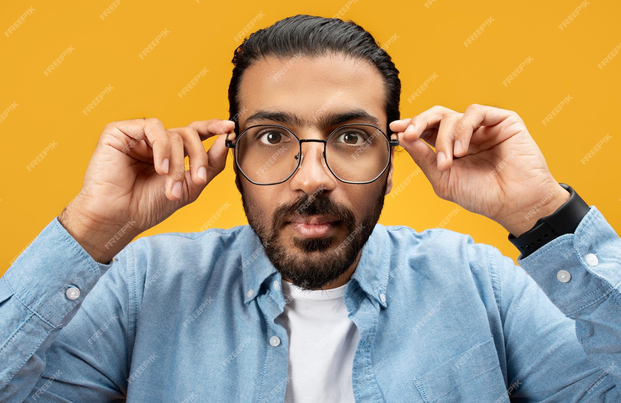Premium Photo Serious Man Adjusting Stylish Round Glasses Wearing A