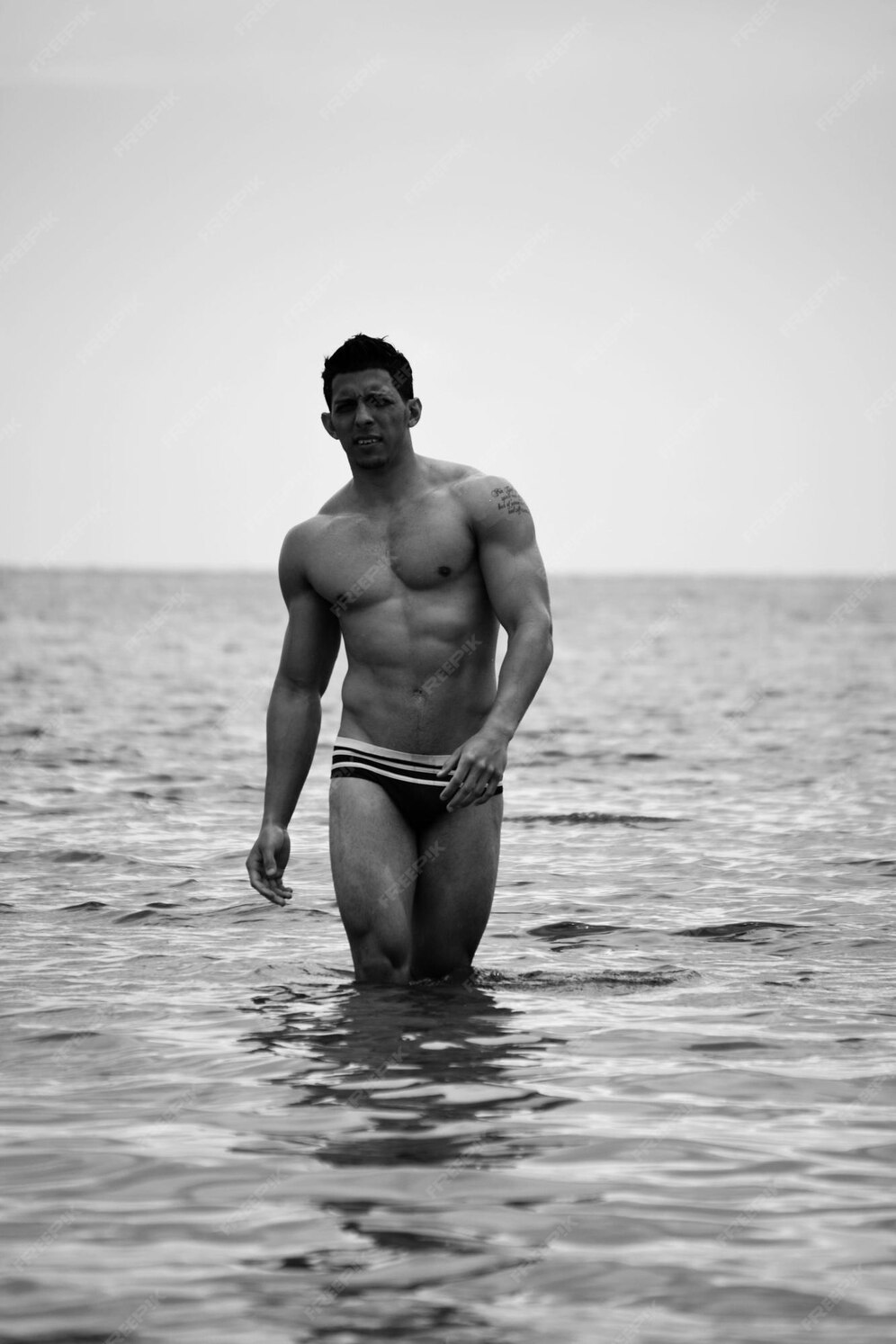 Premium Photo Shirtless Muscular Man Standing In Sea